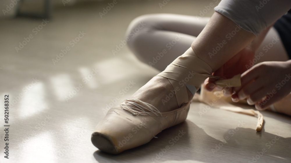 ballet dancer tie up her pointes. Ballet dancer tying ballet shoes ...