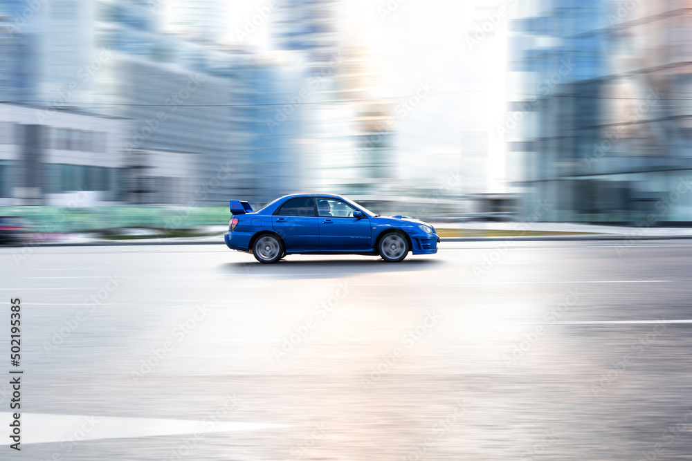 Car Subaru Impreza WRX STI fast speed driving on city road at daytime ...