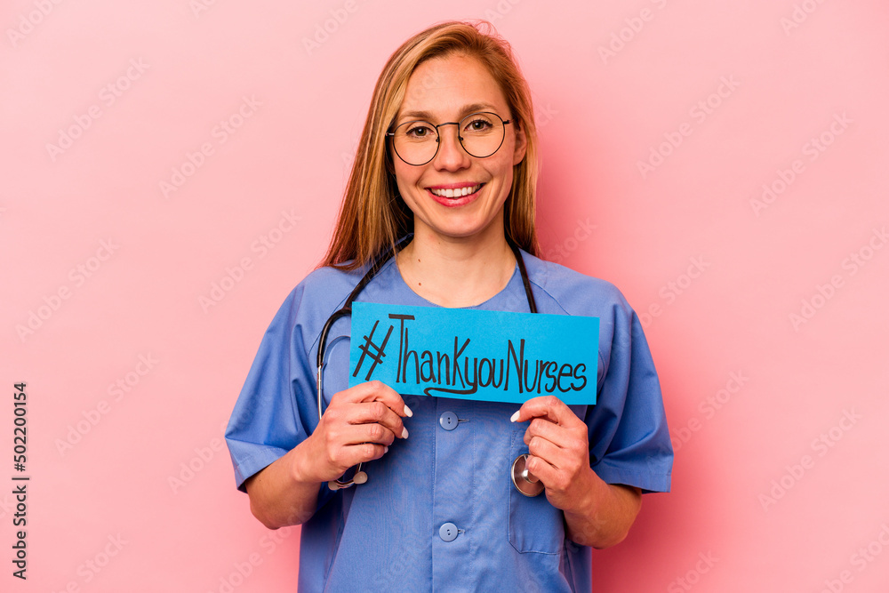 Young nurse woman holding thank you nurses placard isolated on pink ...
