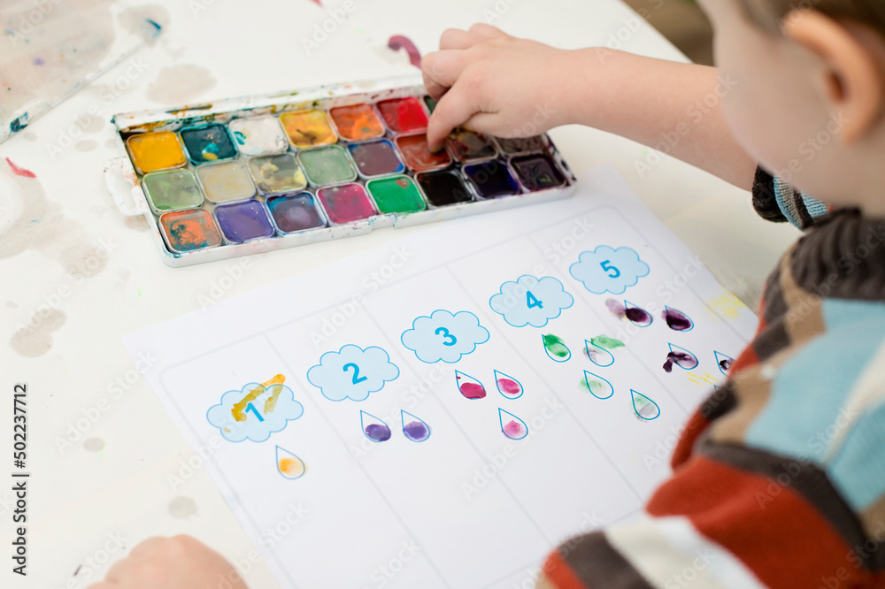 Early education, learning to count. 2 year old boy puts correct amount ...