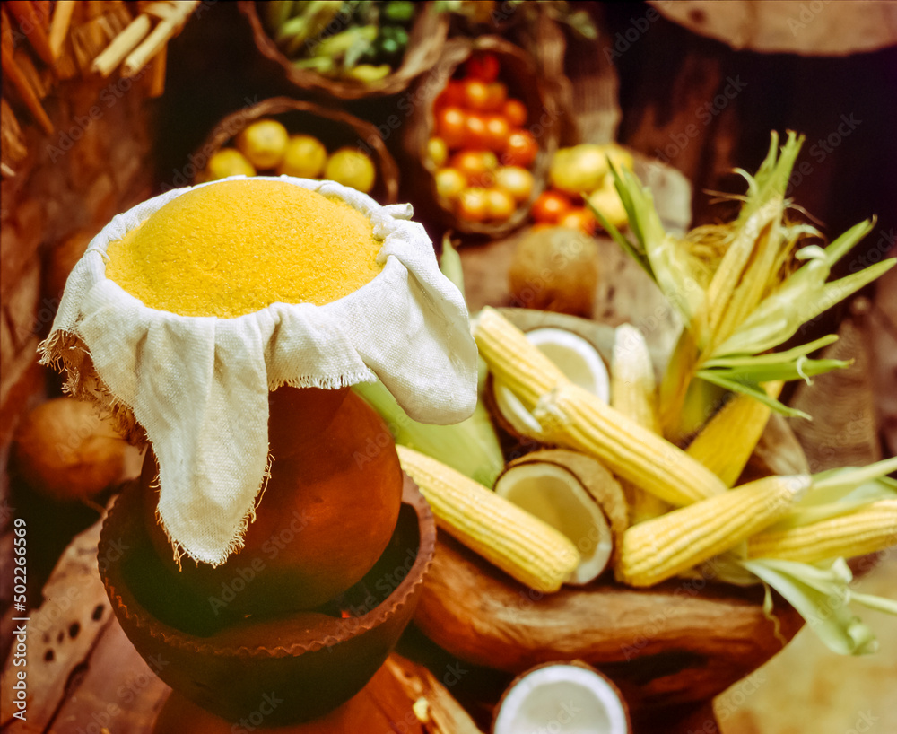 Corn couscous made the old fashioned way in clay pot with blurred ...