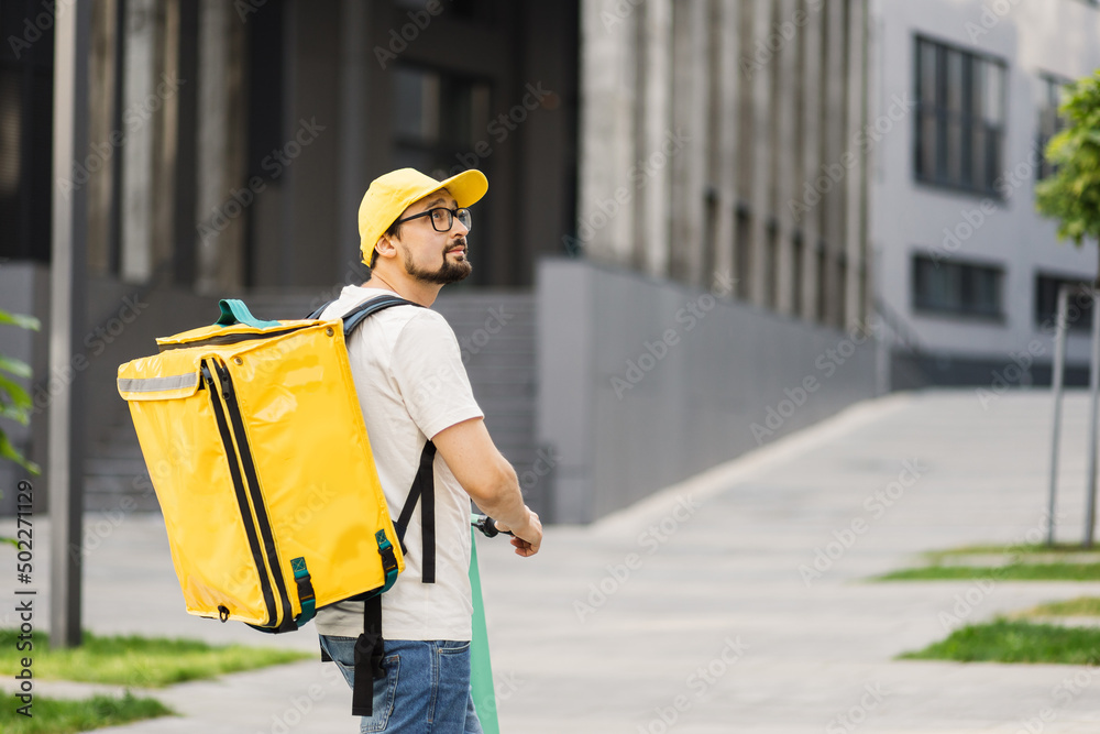 Delivery man of takeaway on scooter with isothermal food case box ...