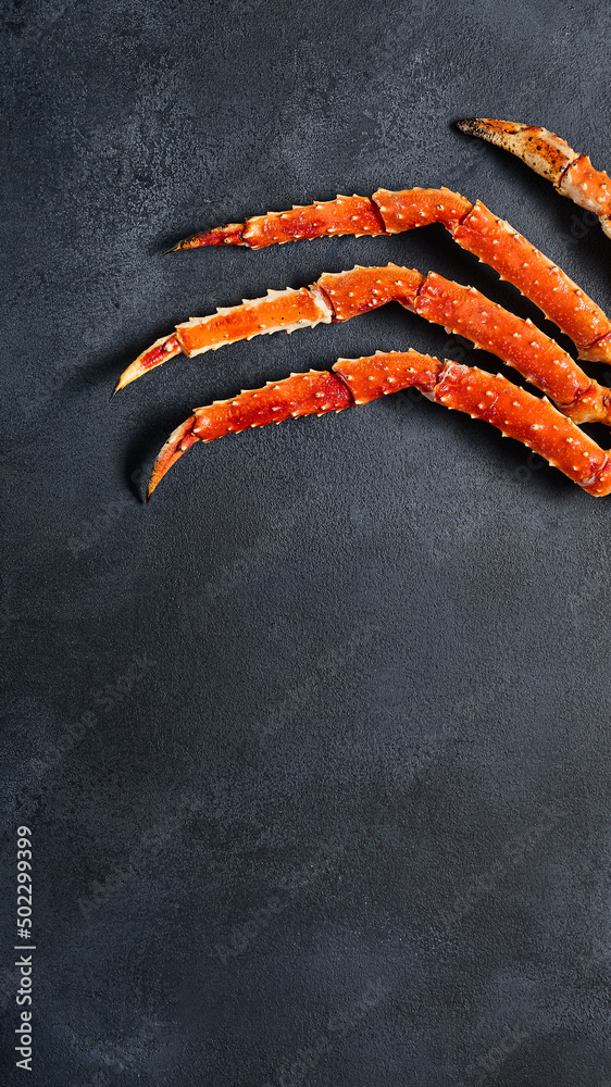 Crab legs top view on dark background. Delicatessen crab seafood on ...