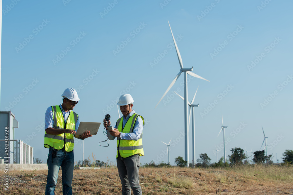 wind turbine and person. workers in the wind. two engineers discussing ...