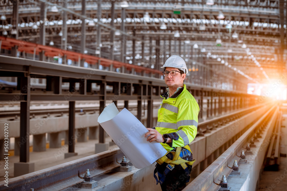 Engineer under inspection and checking construction process railway ...