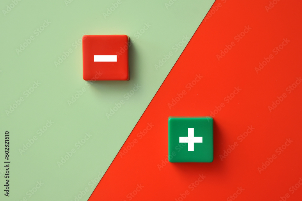 Plus and minus signs on a multi-colored background. Positive and ...