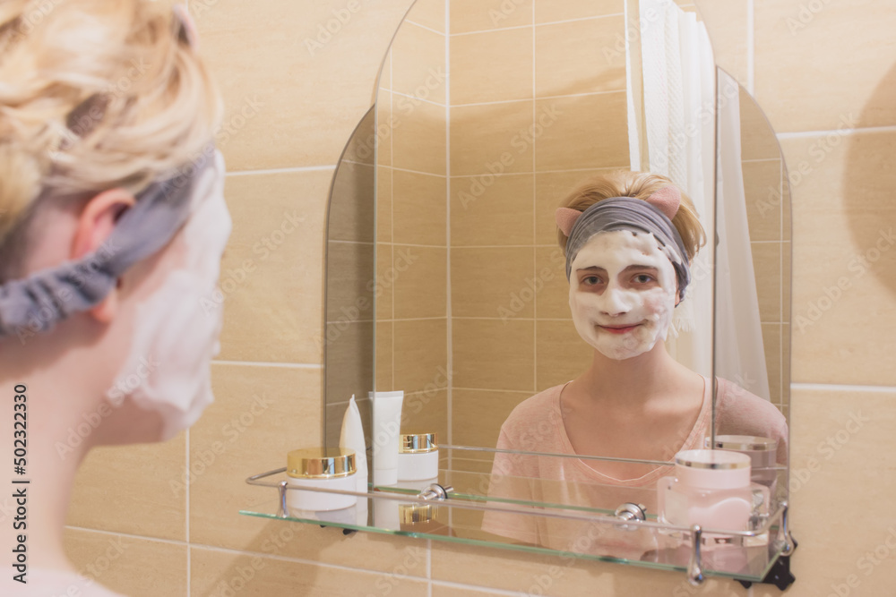 Teenager girl washing her face with foam to prevent pubertal acne ...