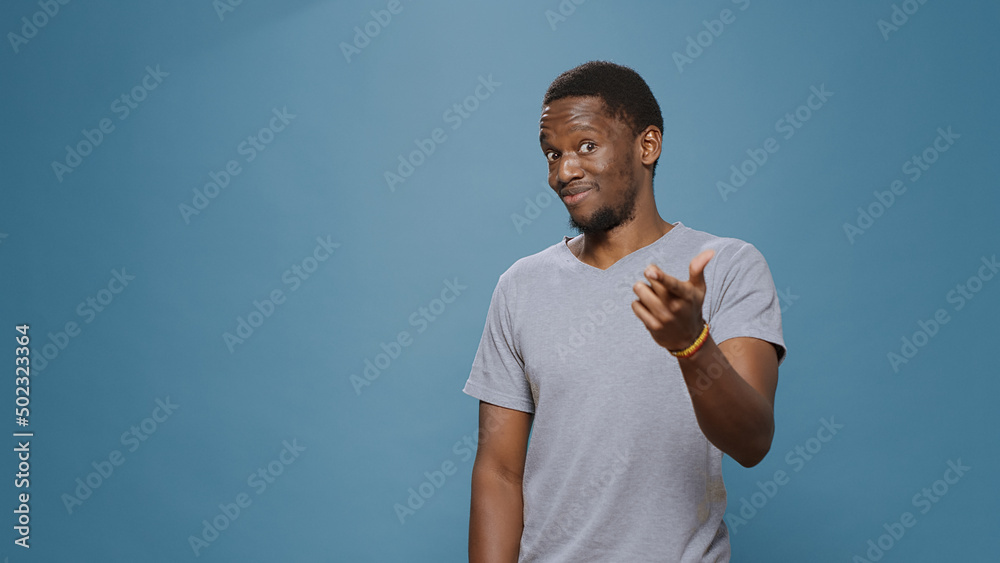 Confident adult pointing at left and right side over blue background ...