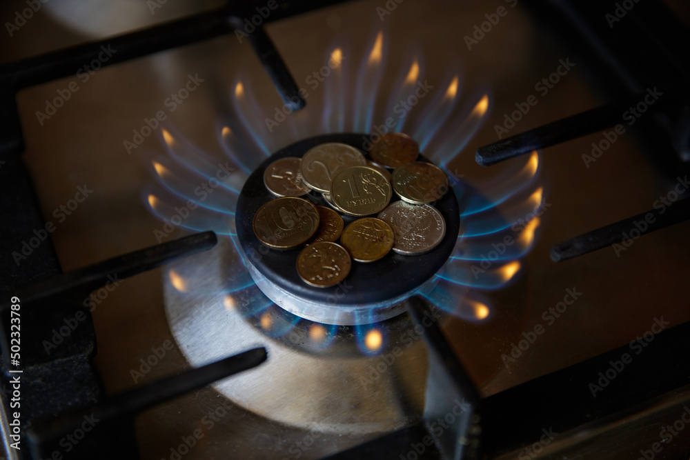 Coin 1 Russian ruble lies on a hot gas burner, burning gas stove, lots ...