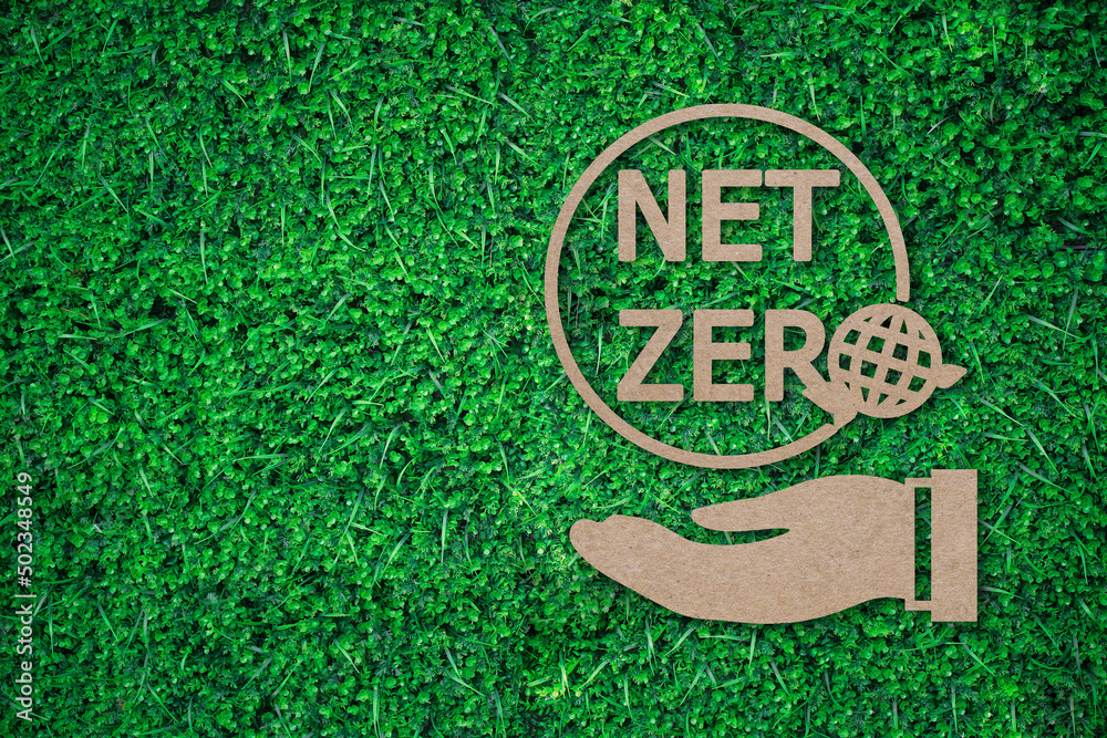 net zero with earth instead of "O" over businessman hand paper cut on ...