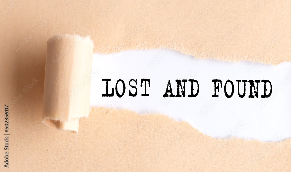 The text LOST AND FOUND appears on torn paper on white background ...