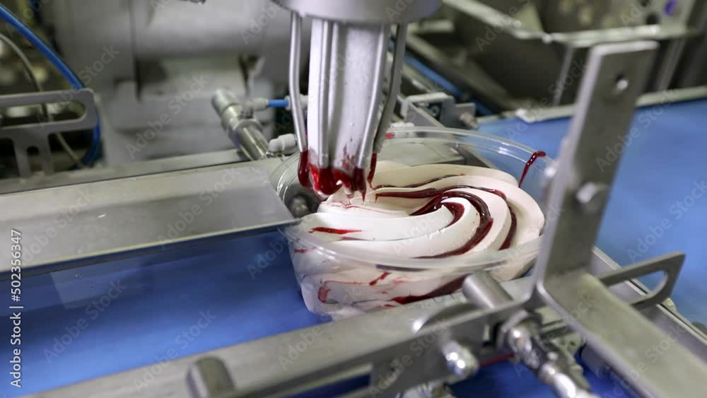 Industrial robot making ice cream. Ice cream production. Automated ...
