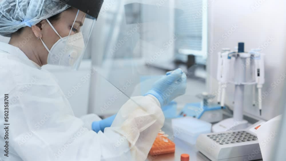 female scientist makes PCR DNA tests in a modern chemical and ...