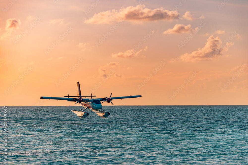 Exotic scene with seaplane on Maldives sea landing. Seaplane landing on ...