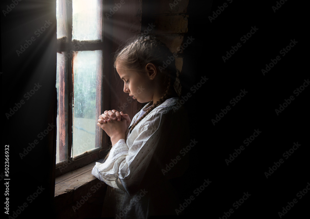 Girl at the window on a black background Stock Photo | Adobe Stock