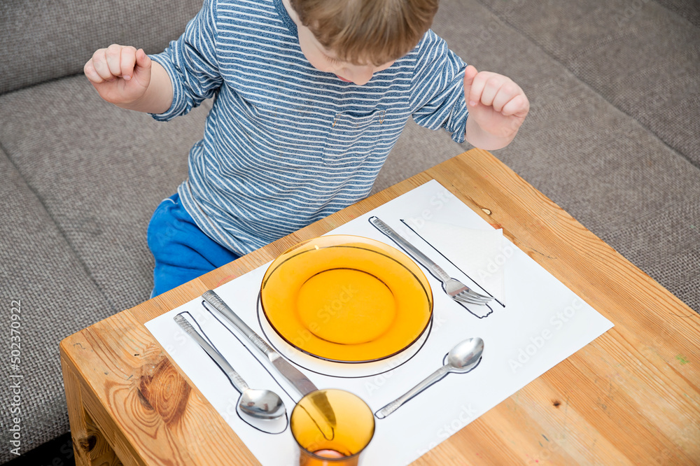 Kid learning to Serve a Table. Task according to Montessori methodology ...