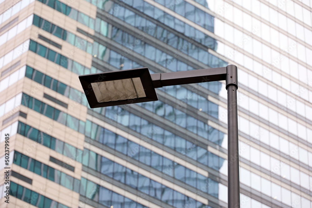 LED street lamp post on skyscraper background. Modern led lights in ...