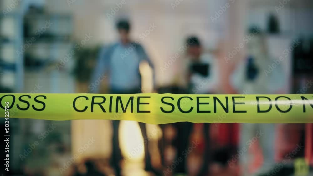 Crime scene tape securing perimeter, detectives conducting murder ...
