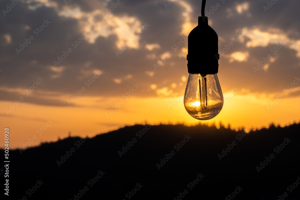 Sunset with sunlight inside a light bulb. Solar energy system. Stock ...