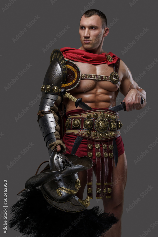 Shot of isolated on grey background roman gladiator holding plumed ...