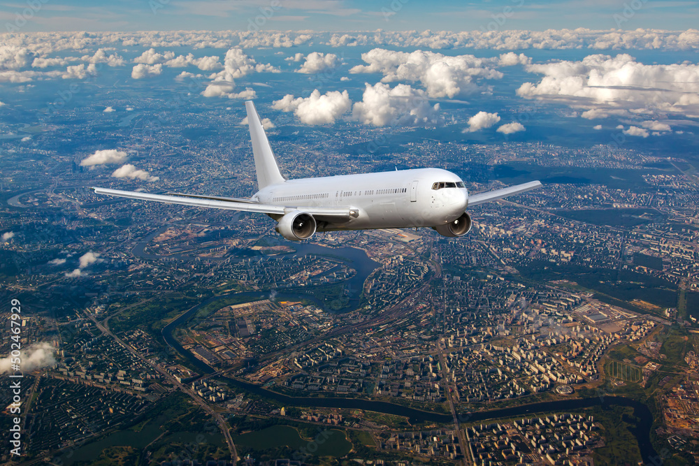 Passenger wide-body plane in flight. Aircraft flies high above the ...
