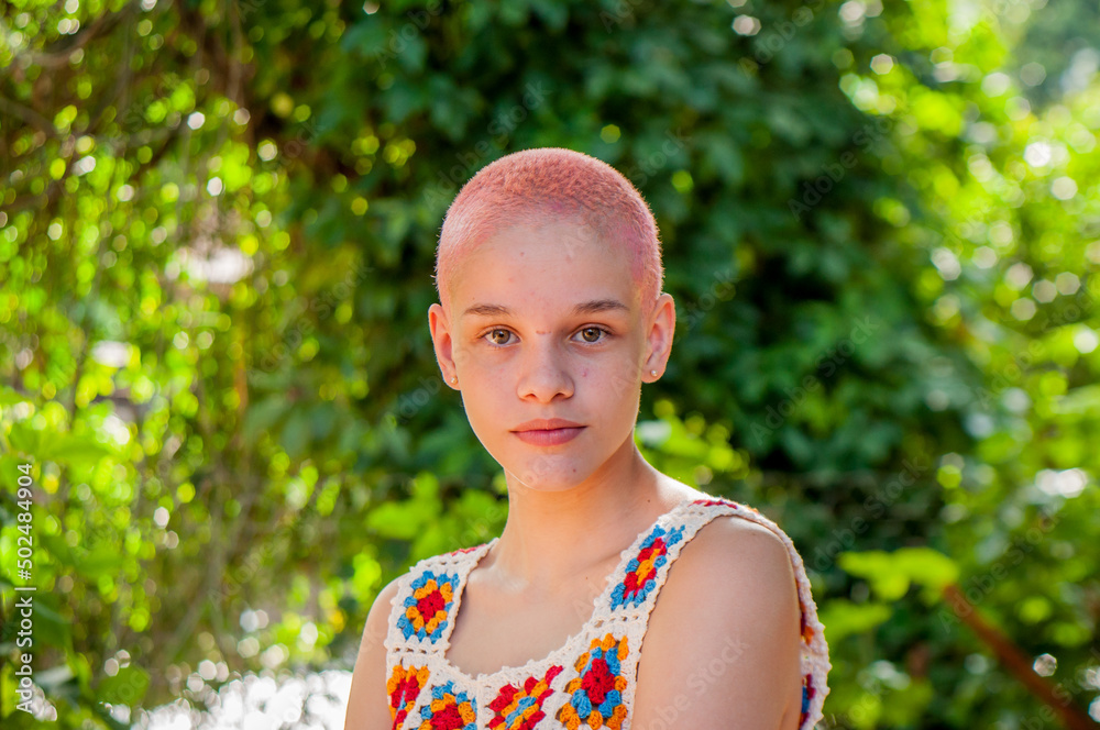 Portrait of a girl with very short hair, dyed pink. Portrait of girl ...