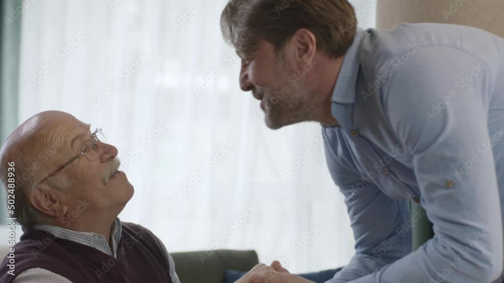 A young man visits his father during Eid Mubarak (Turkish Ramadan or ...