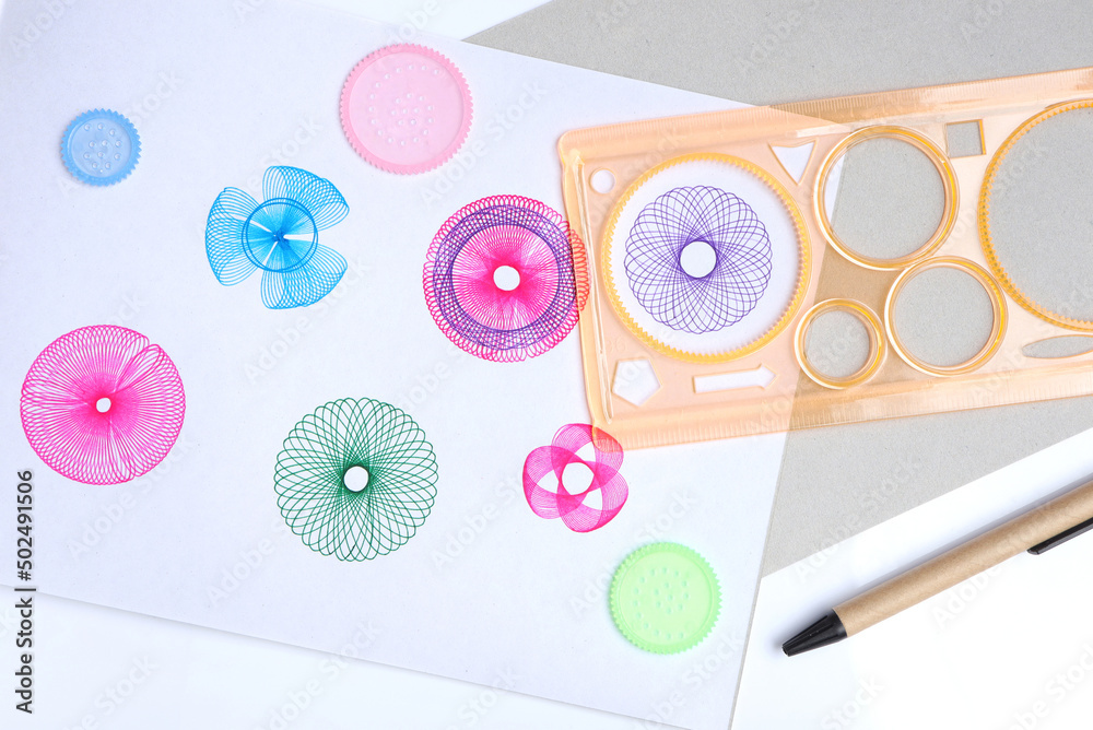 Spirograph ruler on white background. Drawing the spirograph pattern on ...
