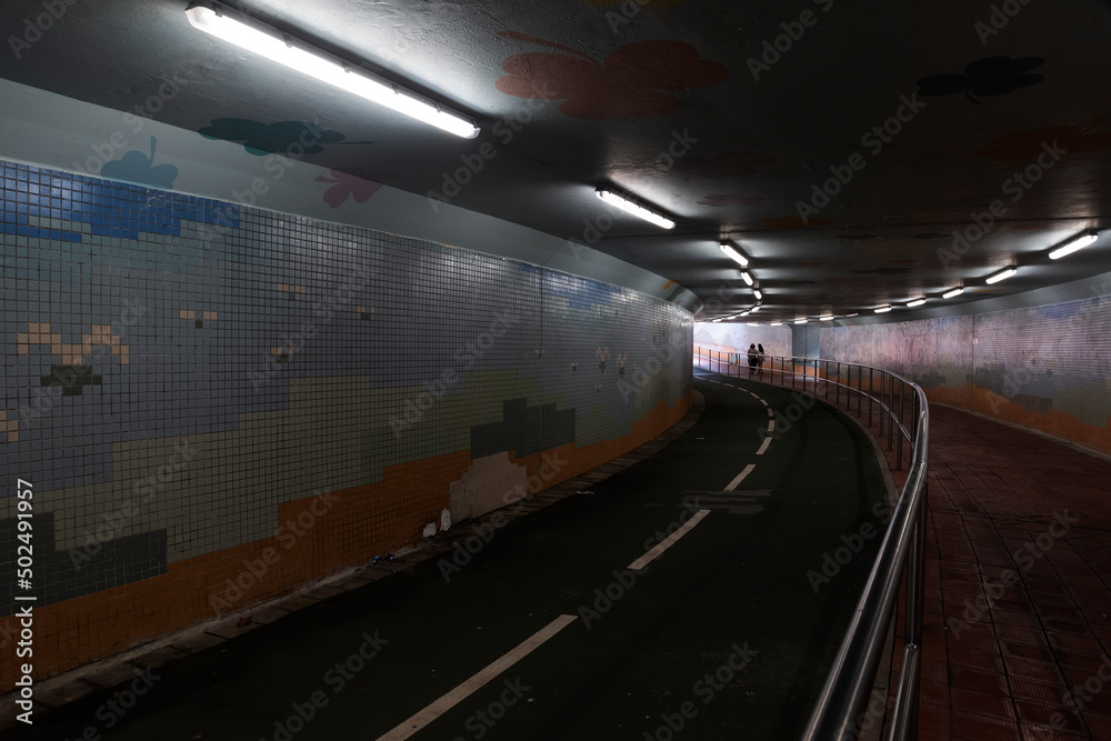 Underground pedestrian crossing. A dark path to light. Geometry of ...