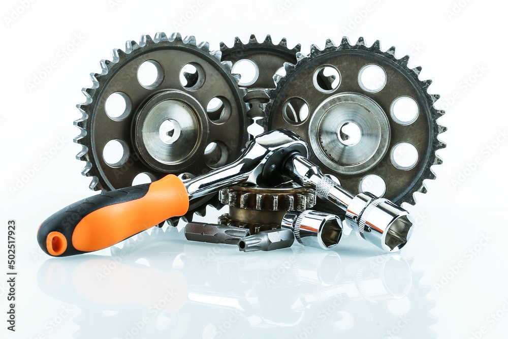 ratchet wrench and car gears are on white background. car parts and ...