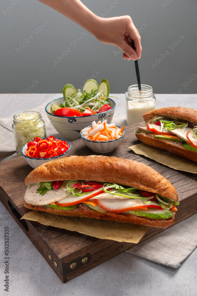 Banh Mi - Vietnamese sandwich with sausage, pork, lettuce, tomato and ...
