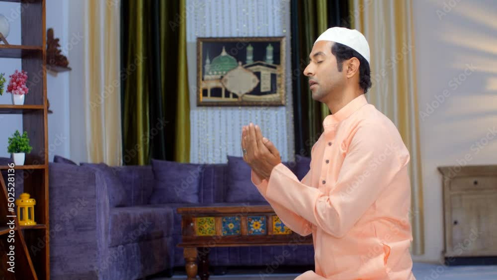 A young man performs Namaz during the festival of Eid - an Islamic ...