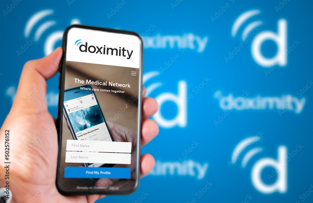 Doximity company website on a phone screen. Blue background with ...