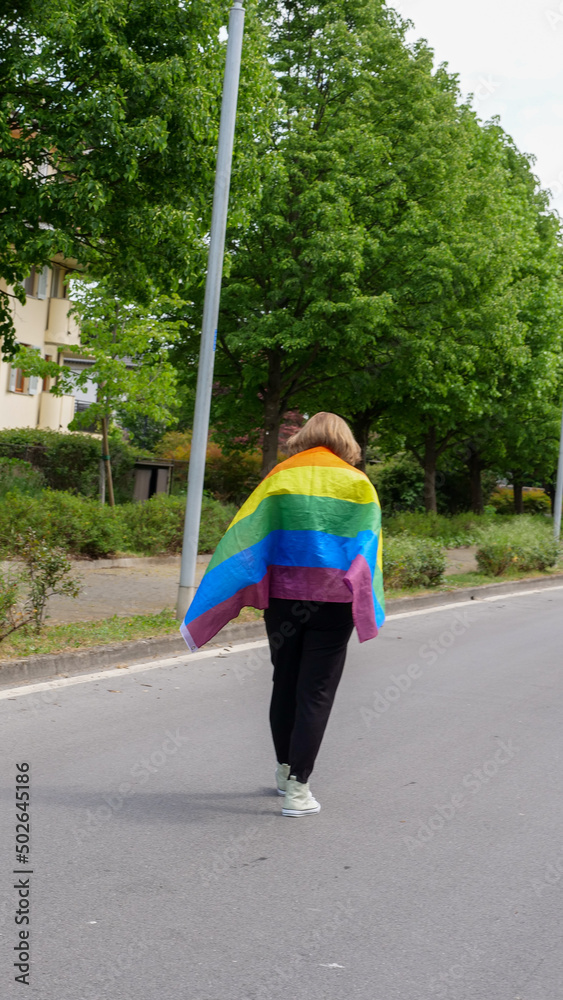 Bisexual Lesbian Woman Transgender Stands With Lgbt Flag Against Blue Sky With Clouds On A