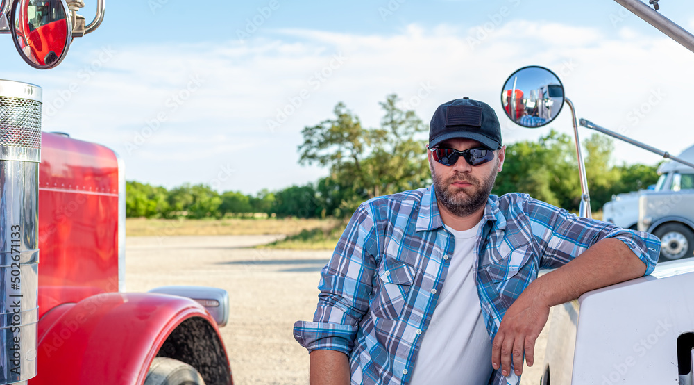 Handsome, professional looking truck driver wearing blue plaid shirt ...