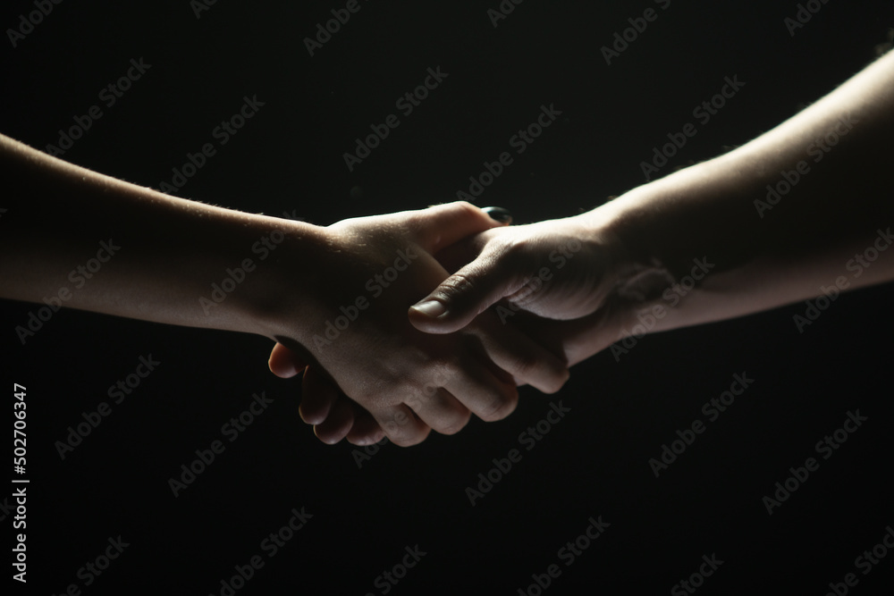 Hands gesturing on black background. Giving a helping hand. Support and ...