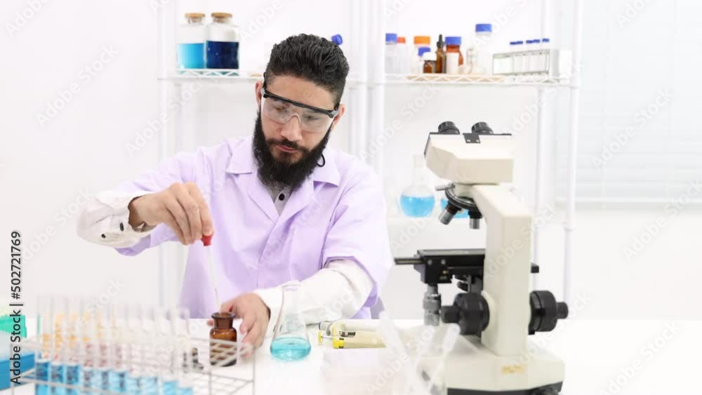 Scientists drop a solution in a lab flask. Makes the blue water in the ...