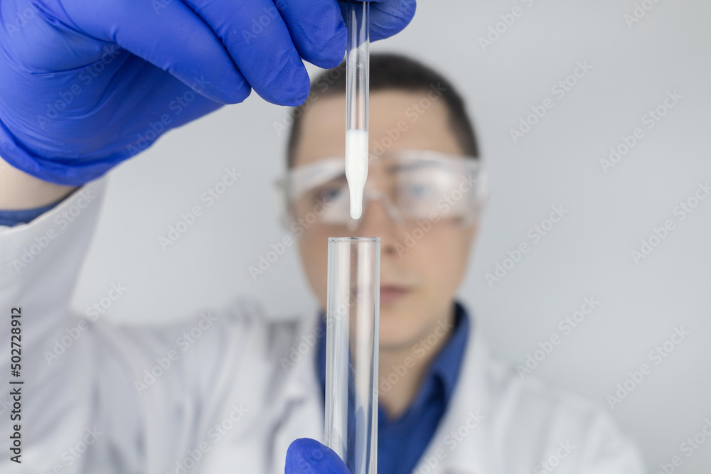 Medical laboratory assistant checks a test tube with sperm. Spermogram ...