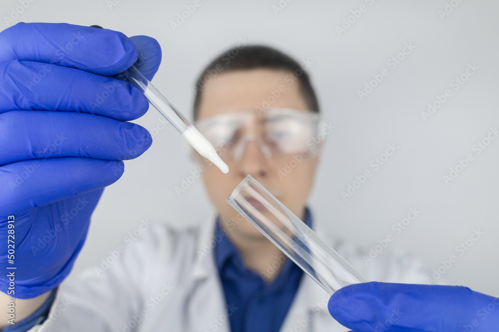 Medical laboratory assistant checks a test tube with sperm. Spermogram ...