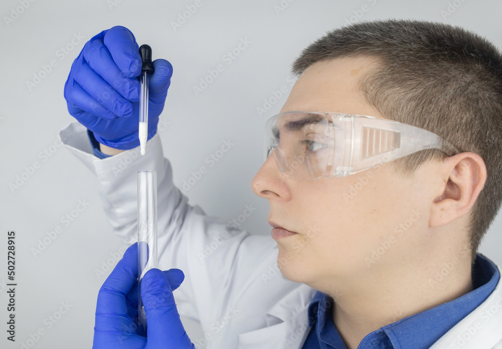 Medical laboratory assistant checks a test tube with sperm. Spermogram ...