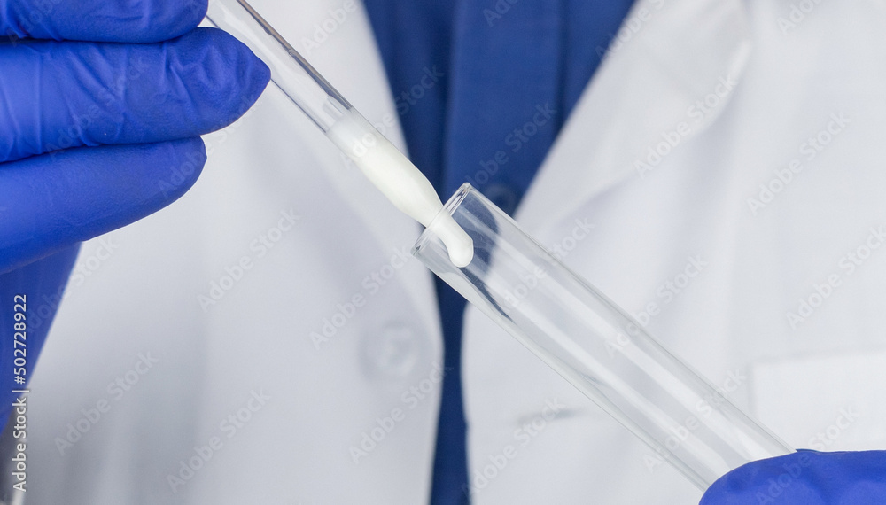 Medical laboratory assistant checks a test tube with sperm. Spermogram ...
