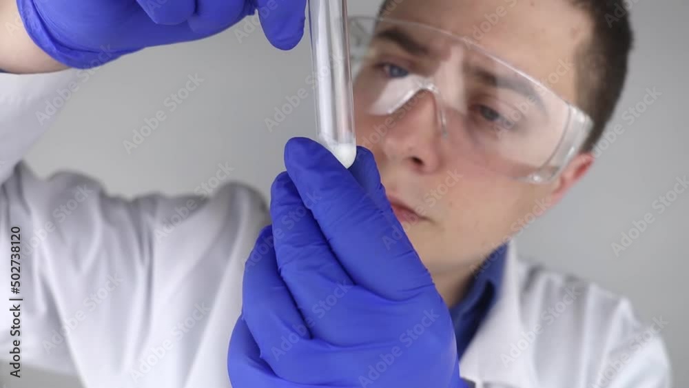 Medical laboratory assistant checks a test tube with sperm. Spermogram ...