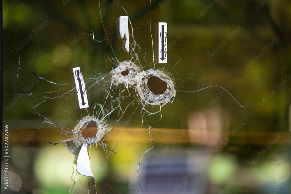Stockfoto Bullet holes on the window of local restaurant, shot during ...