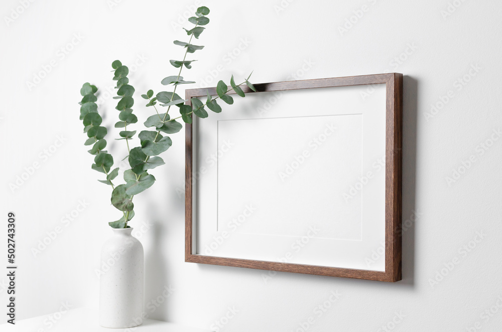 Blank landscape frame mockup for artwork or picture on white wall with ...