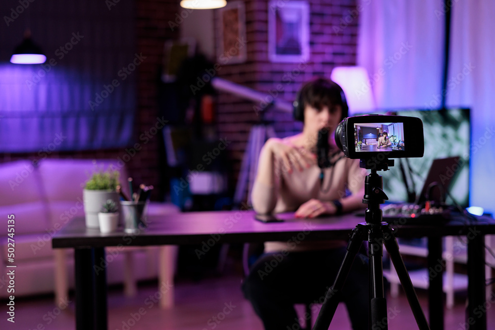 Caucasian woman recording online podcast discussion on camera, vlogging ...