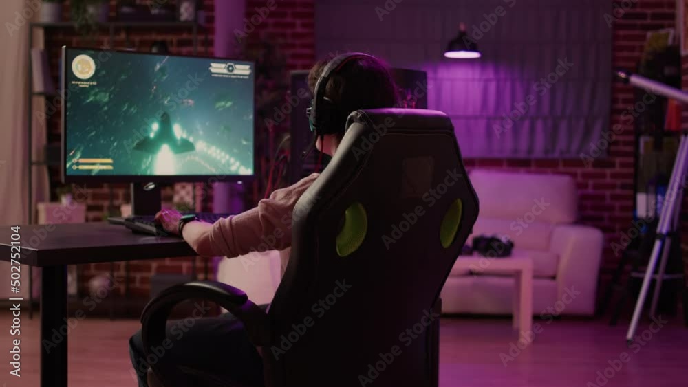 Over shoulder view of gamer girl relaxing playing rpg action game on ...