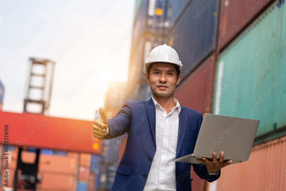 Supervisor working in the container yard, Engineer man with laptop and ...
