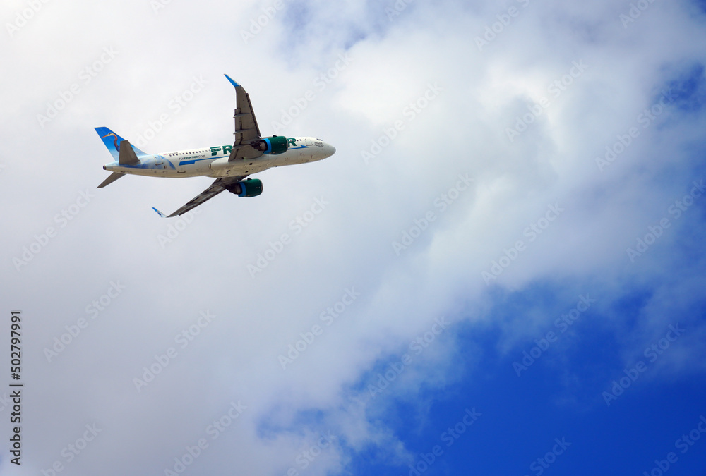 MIAMI, FL -13 MAR 2022- View of an airplane in flight from lowcost ...
