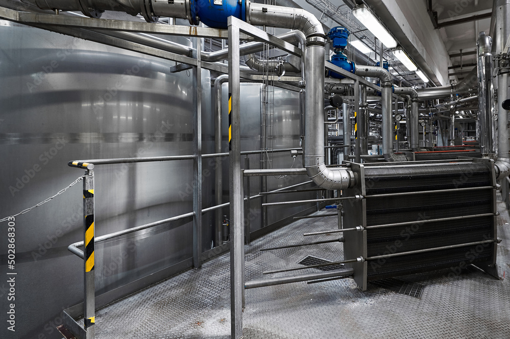 Tanks of stainless steel and heat-exchange unit at plant Stock Photo ...