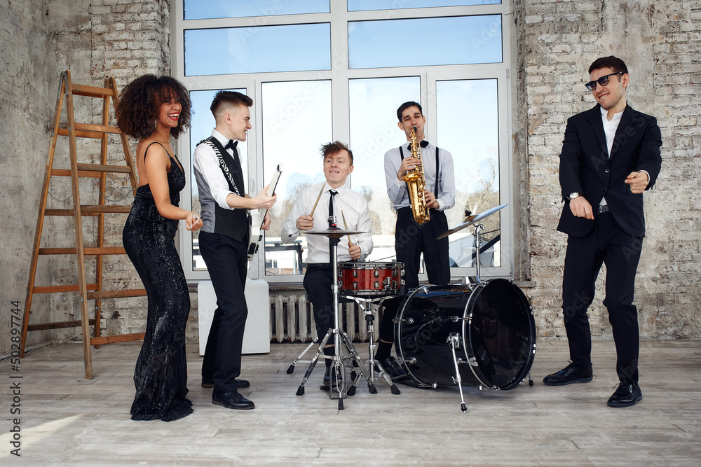 Repetition of multi ethnic jazz band in loft. Bass guitar player ...